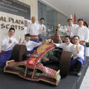 Culinary team builds life-sized coffee capsules race car at Royal Plaza ...